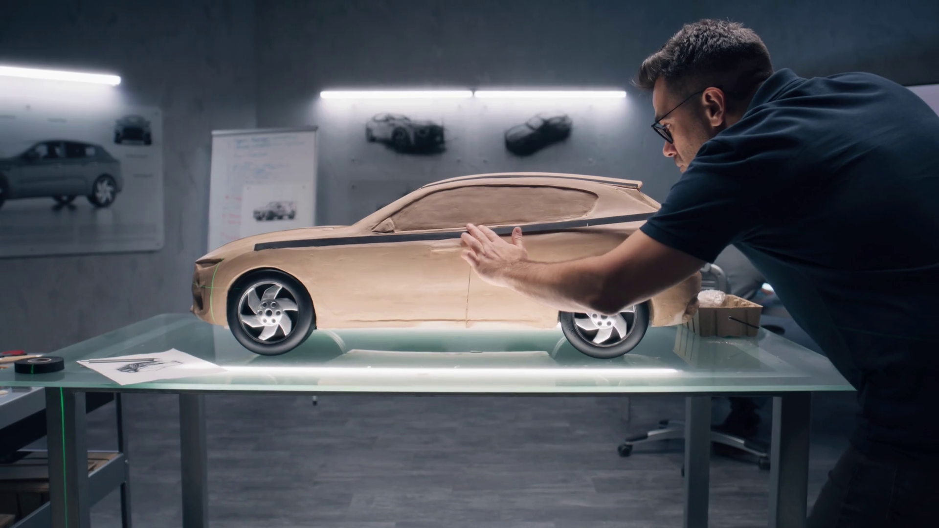 Two male automotive designers creating model of car in modern car ...
