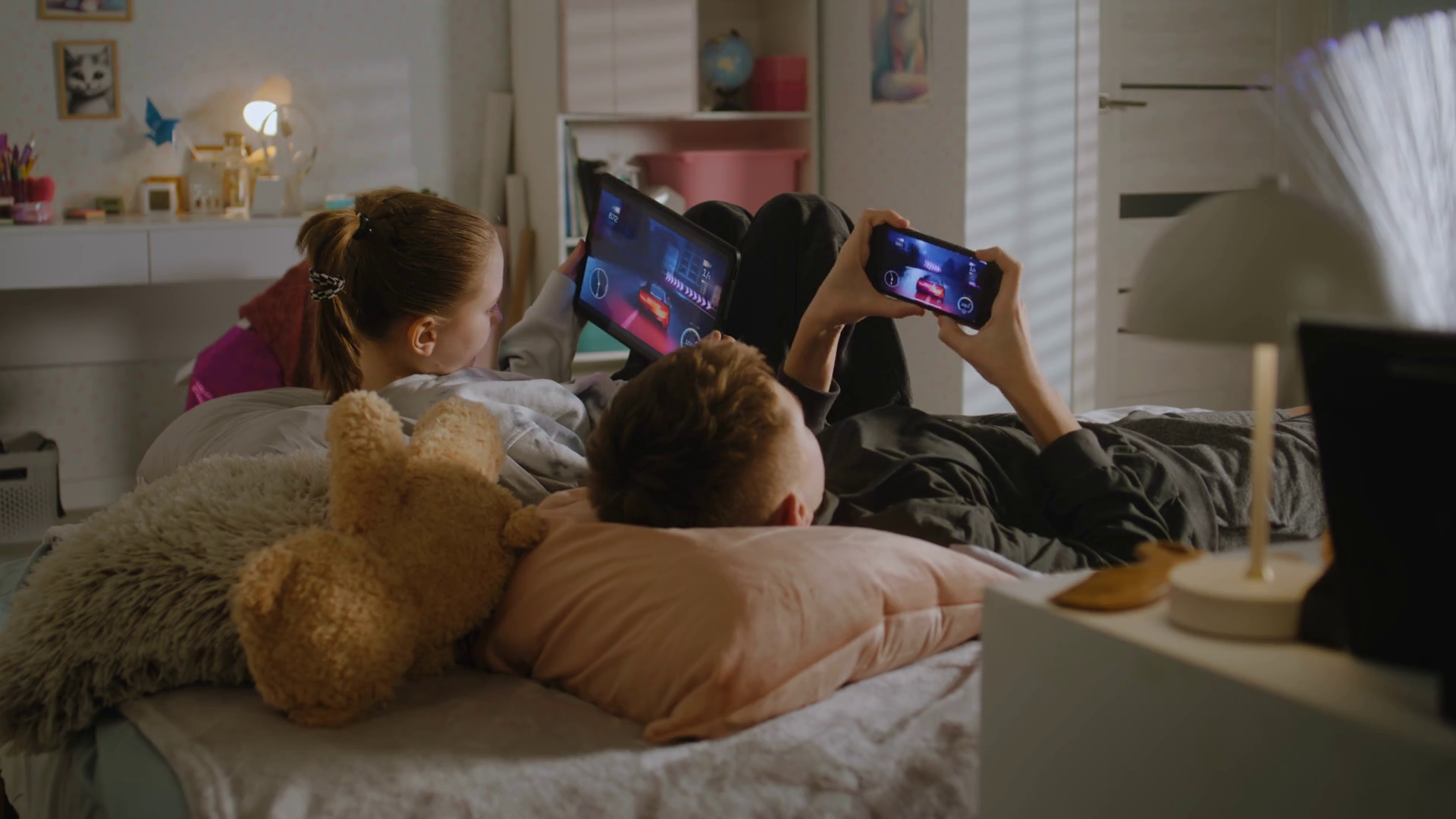 Two Teenagers Lie On Bed In Room Play Video Stock Footage SBV-348900552 ...