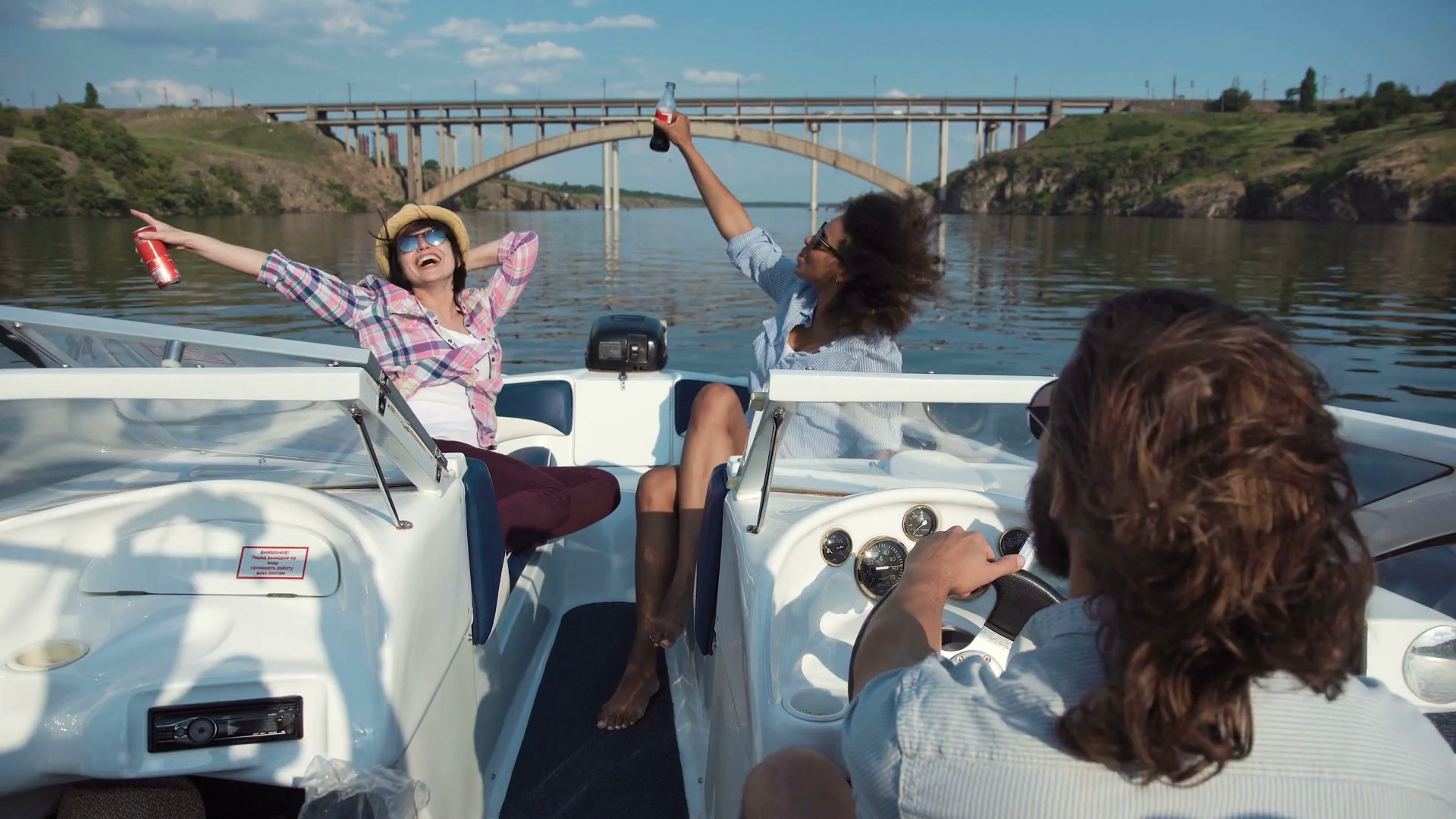 Group of diverse happy women relaxing on board a motor boat as they ...