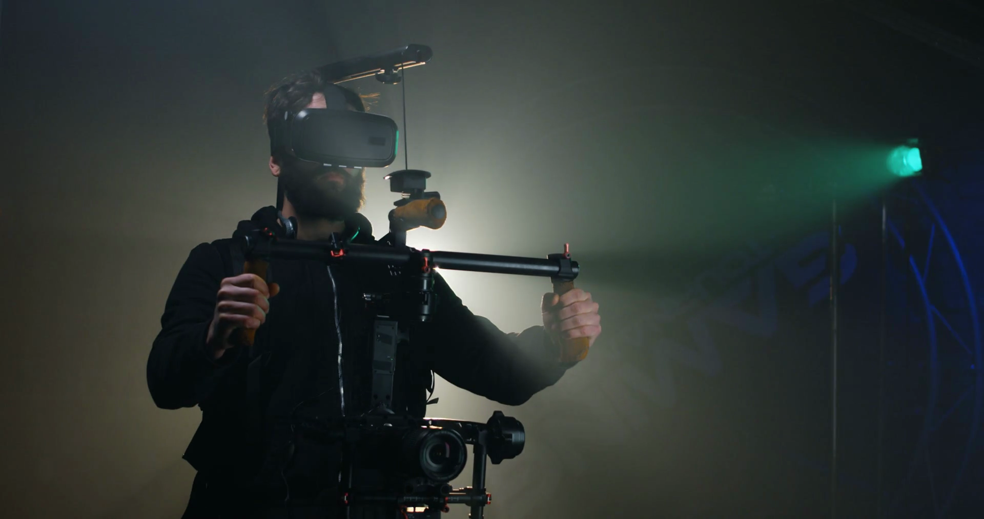 Medium shot of a young cameraman shooting a scene with a steadicam ...