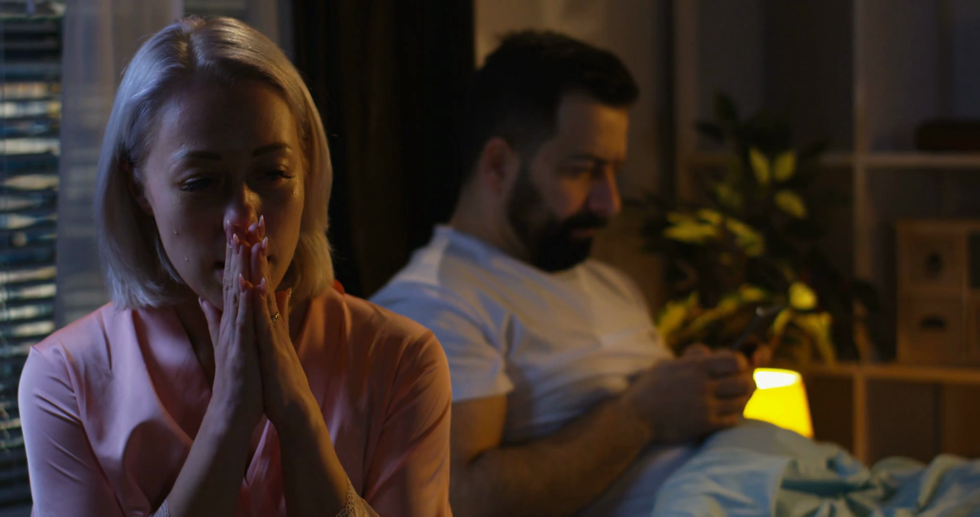 Medium shot of couple crying in bed at night Stock Video Footage 00:24 ...