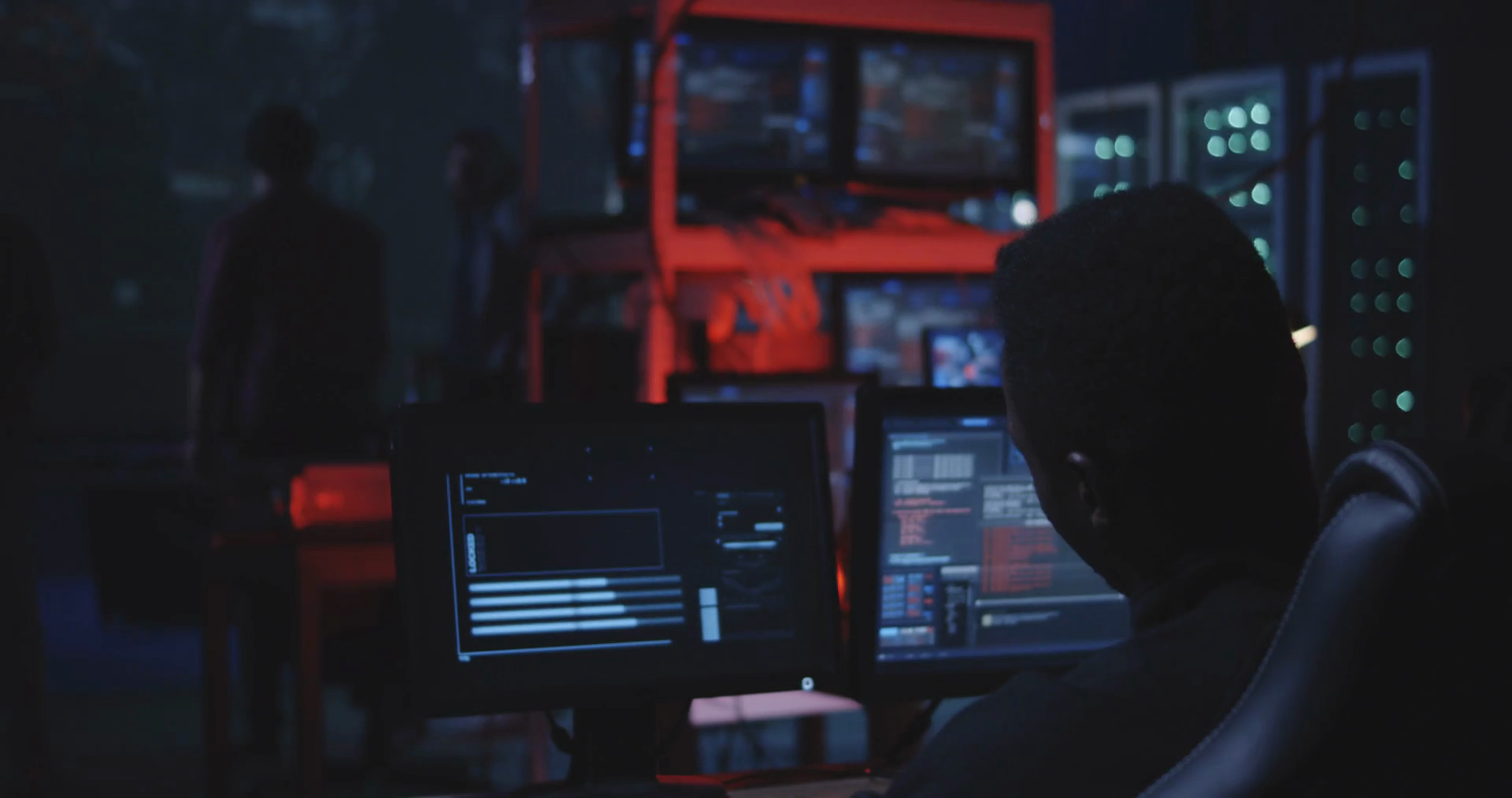Medium shot of four young hackers working in front of a world map ...