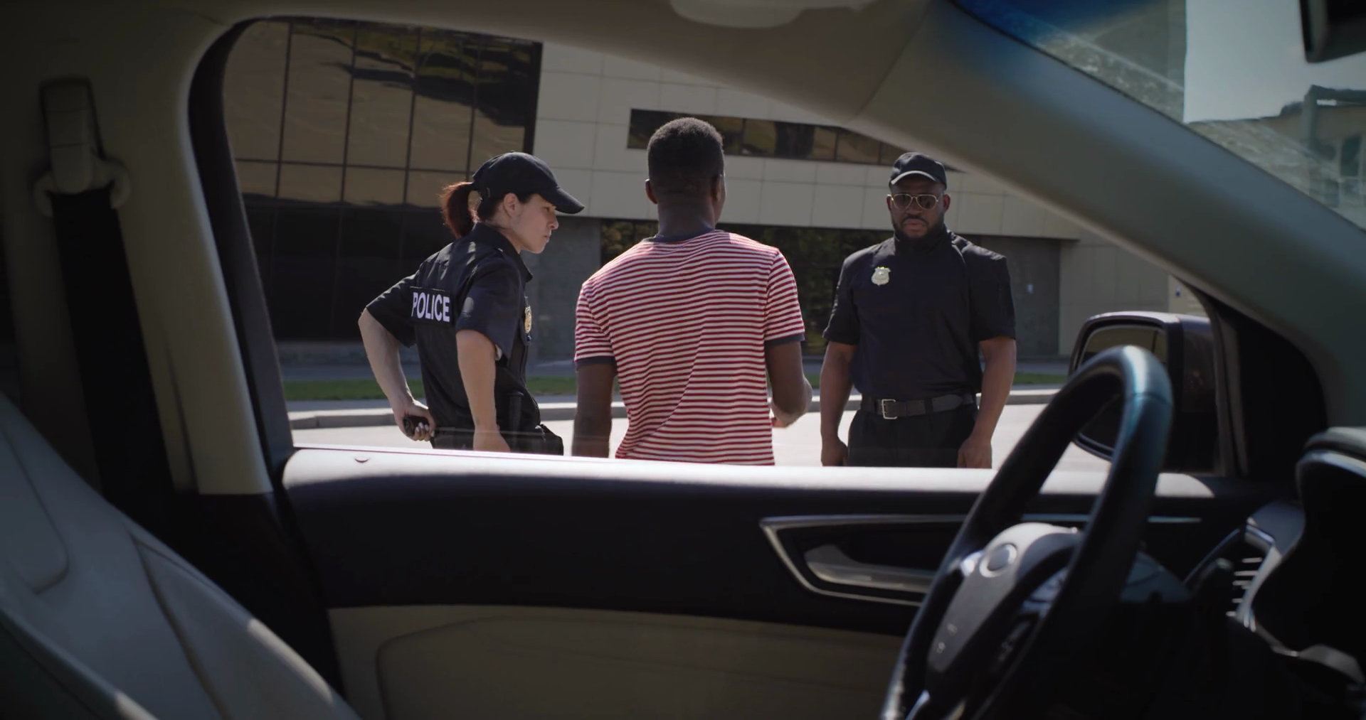 Zoom out view of African American man giving driver license to ...