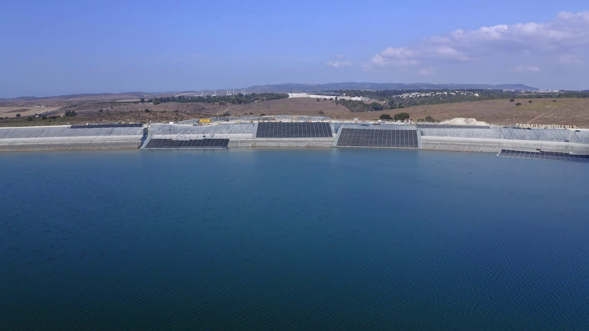 Aerial shot of an agricultural water reservoir surrounded by fields ...