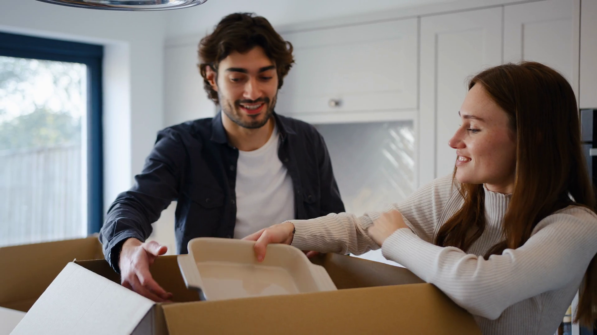 Excited Couple In Kitchen Of New Home Unpack Stock Footage SBV ...
