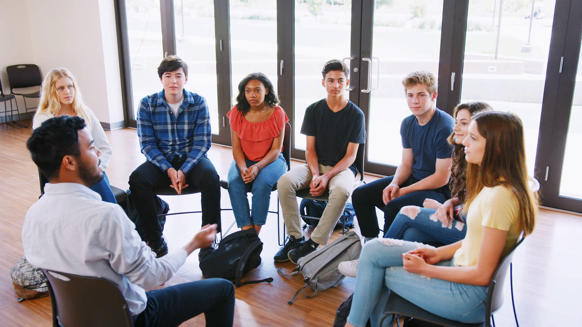 Male Tutor Leading Discussion Group Amongst High School Pupils Stock ...