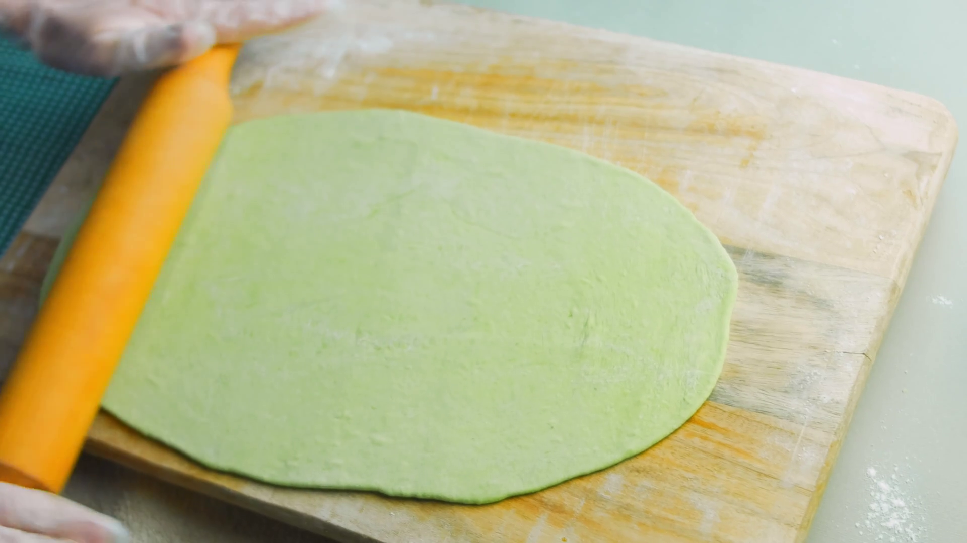 The chef spreads the green dough with a rolling pin Stock Video Footage ...