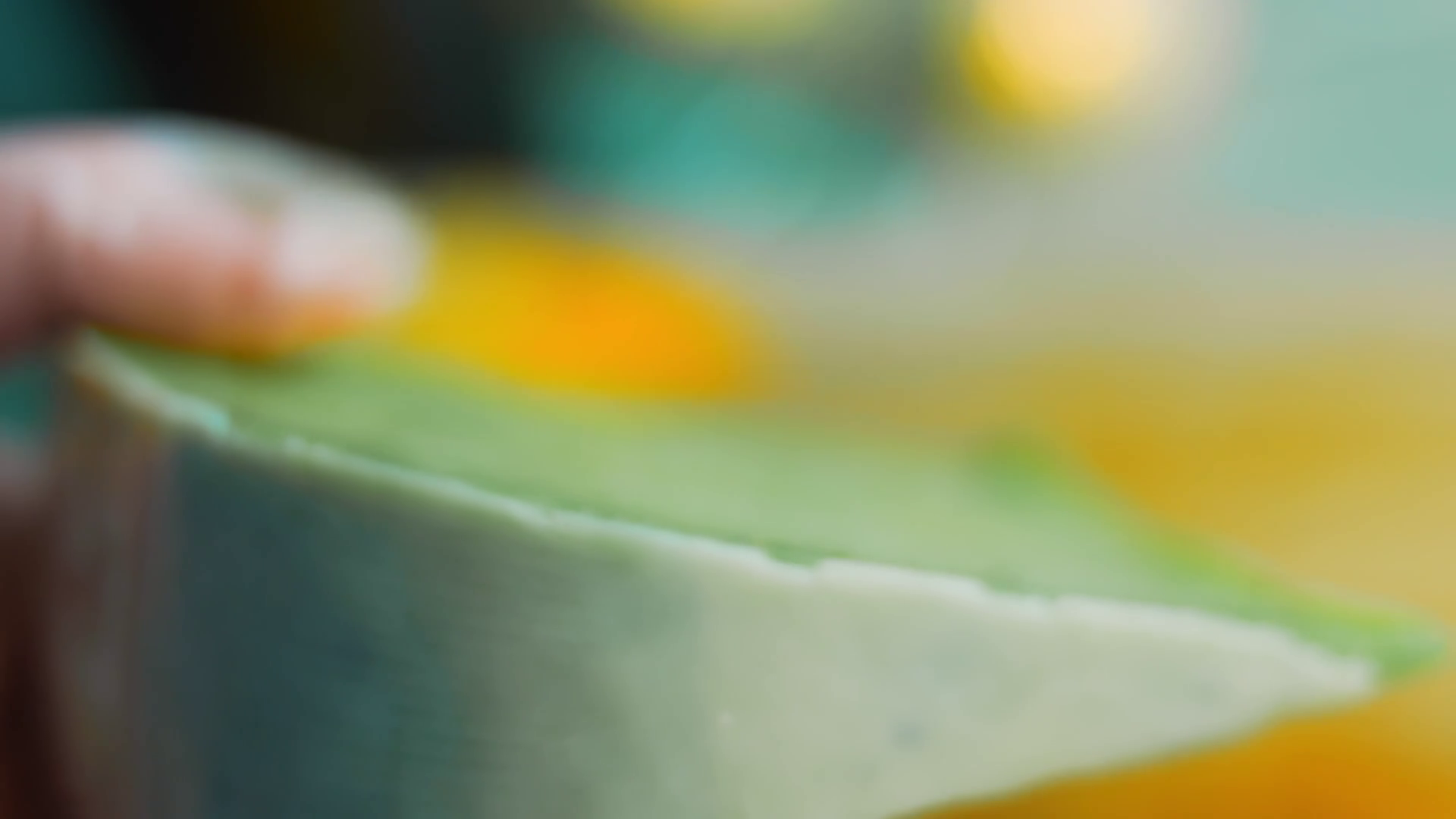 I pull out the green pesto cheese film with a knife. Macro shooting ...