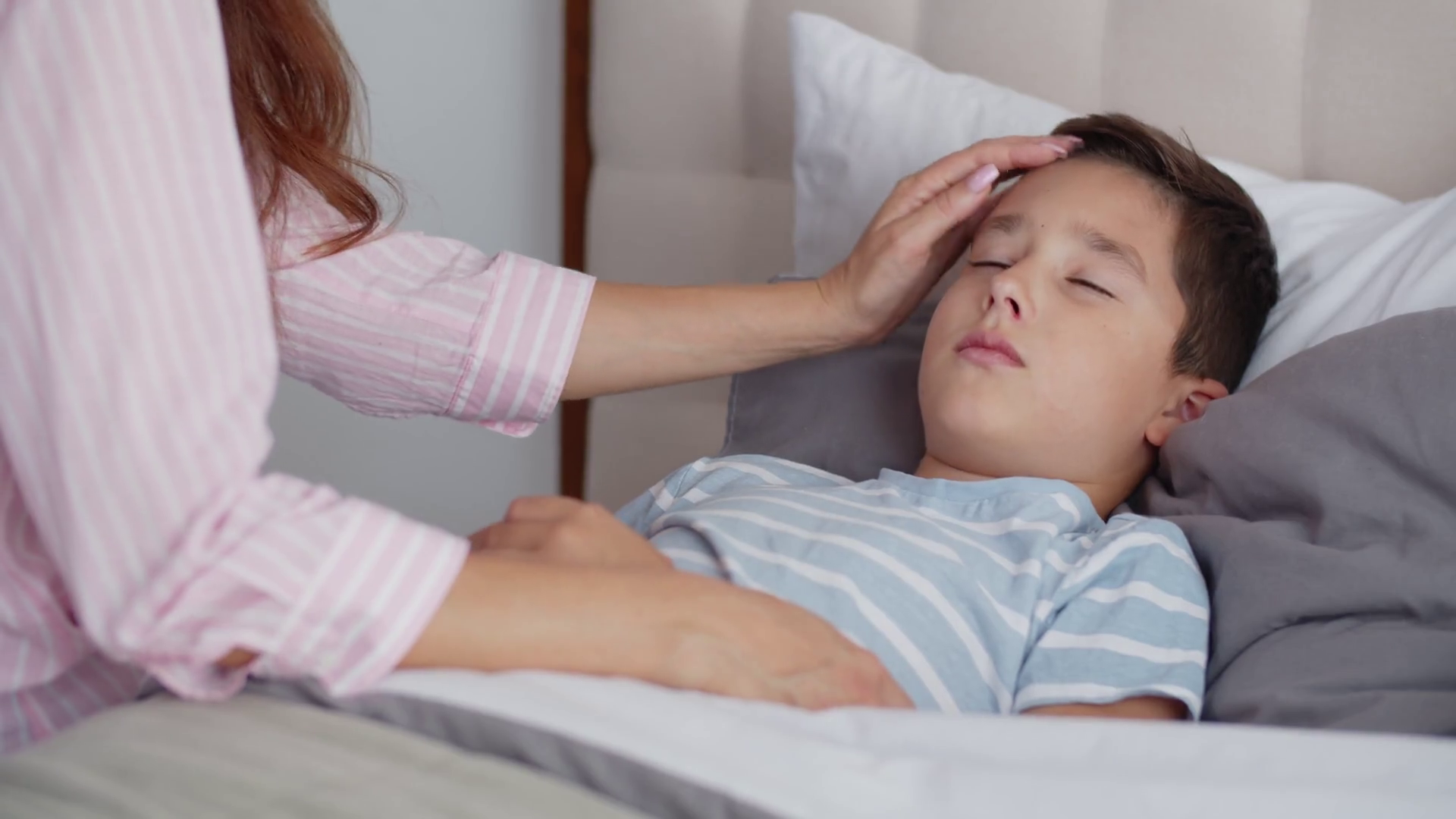 Close Up View Of Mother Calming Ill Boy With Stock Footage SBV ...