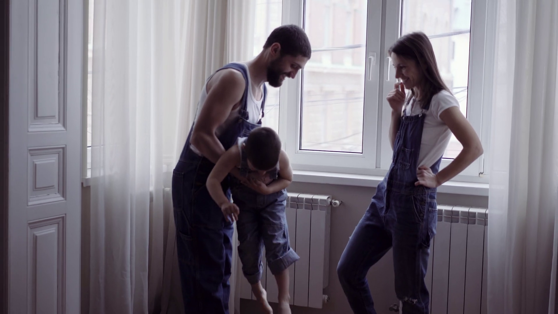 Cute Family Standing At Window Of New Home Stock Footage SBV-333337479 ...