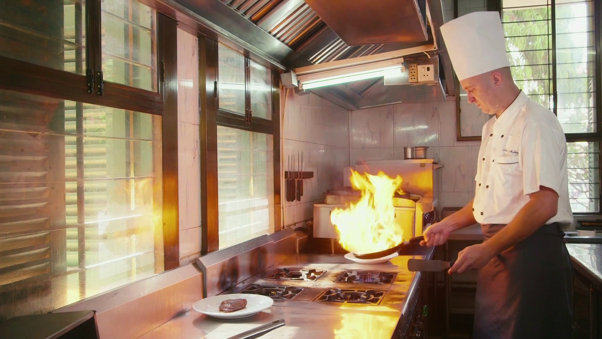 Chef cooking, preparing food, professional cook in restaurant kitchen ...