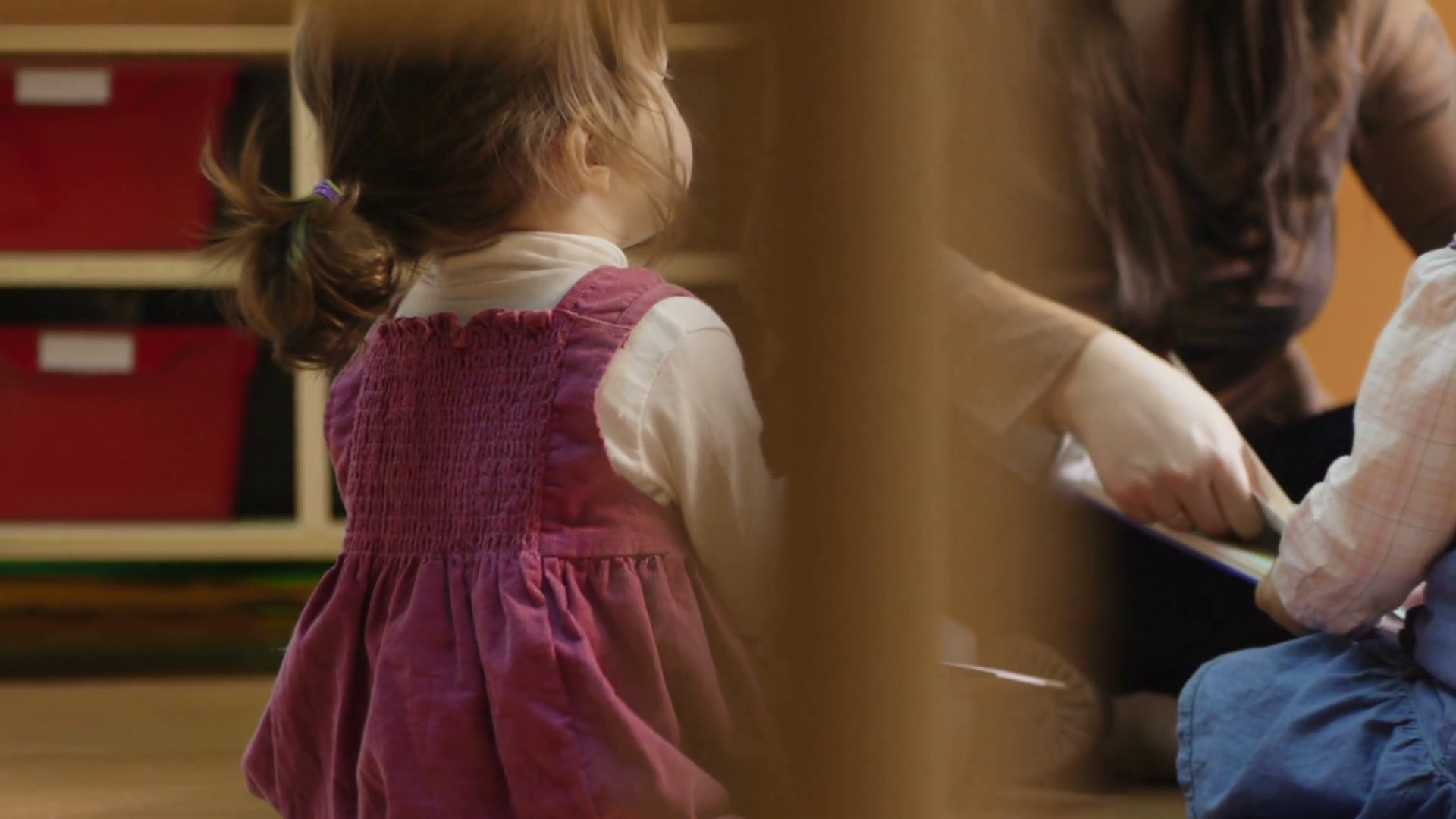Educator and little baby girls reading fairy tale at preschool, teacher ...