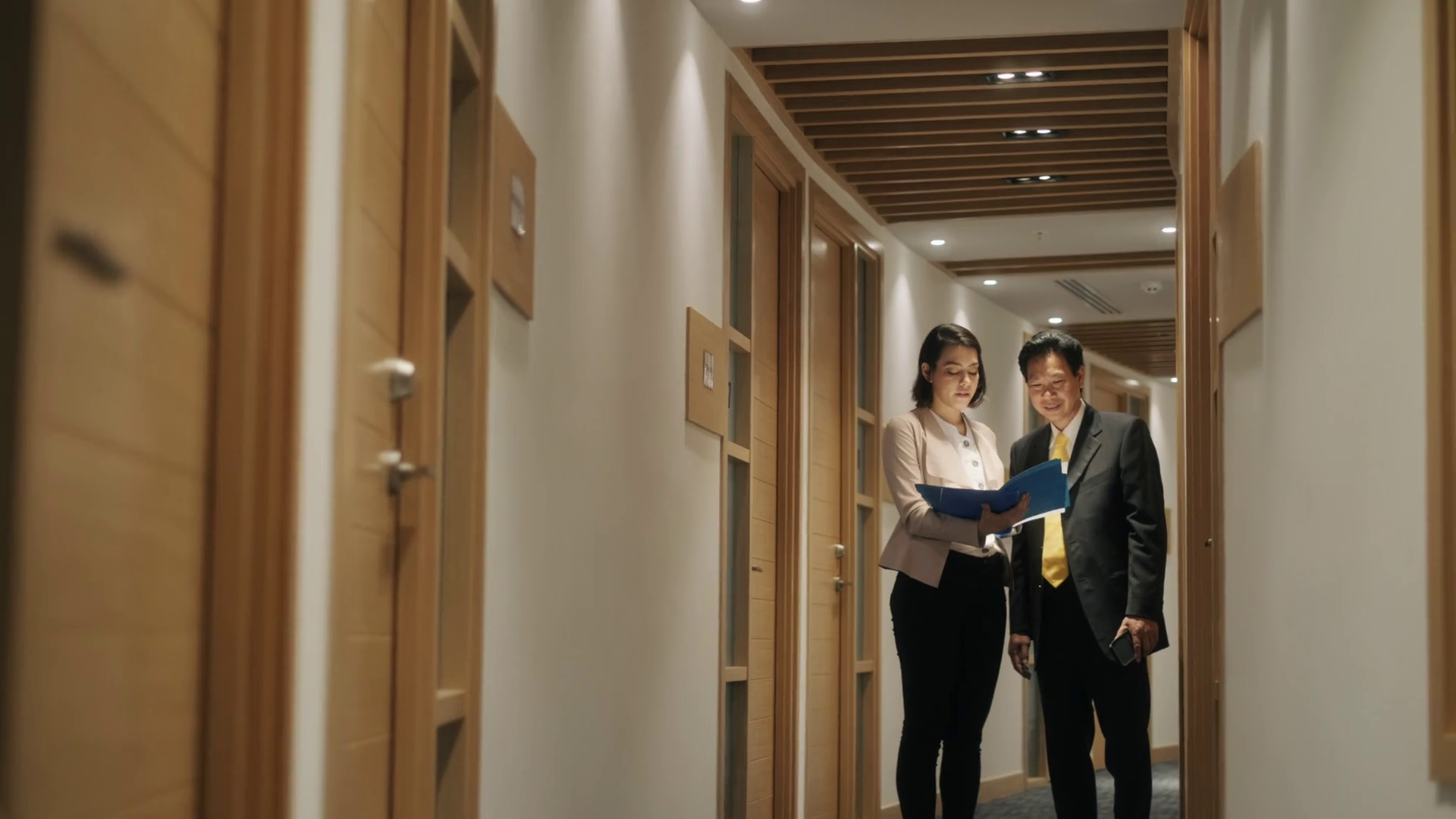 Businesswoman Explaining Documents To Happy Chinese Client In Bank ...