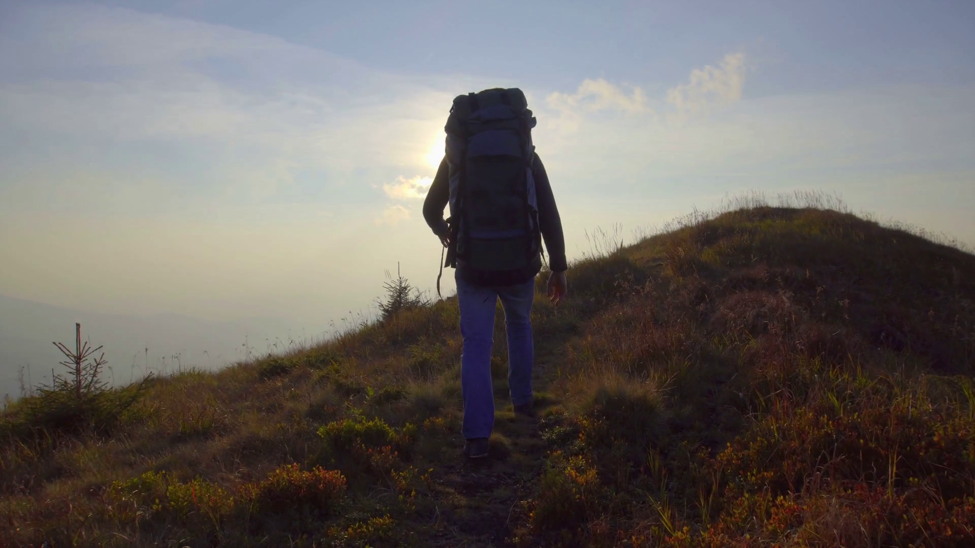 4 in 1 video! The man walk to the top of the mountain on the background ...
