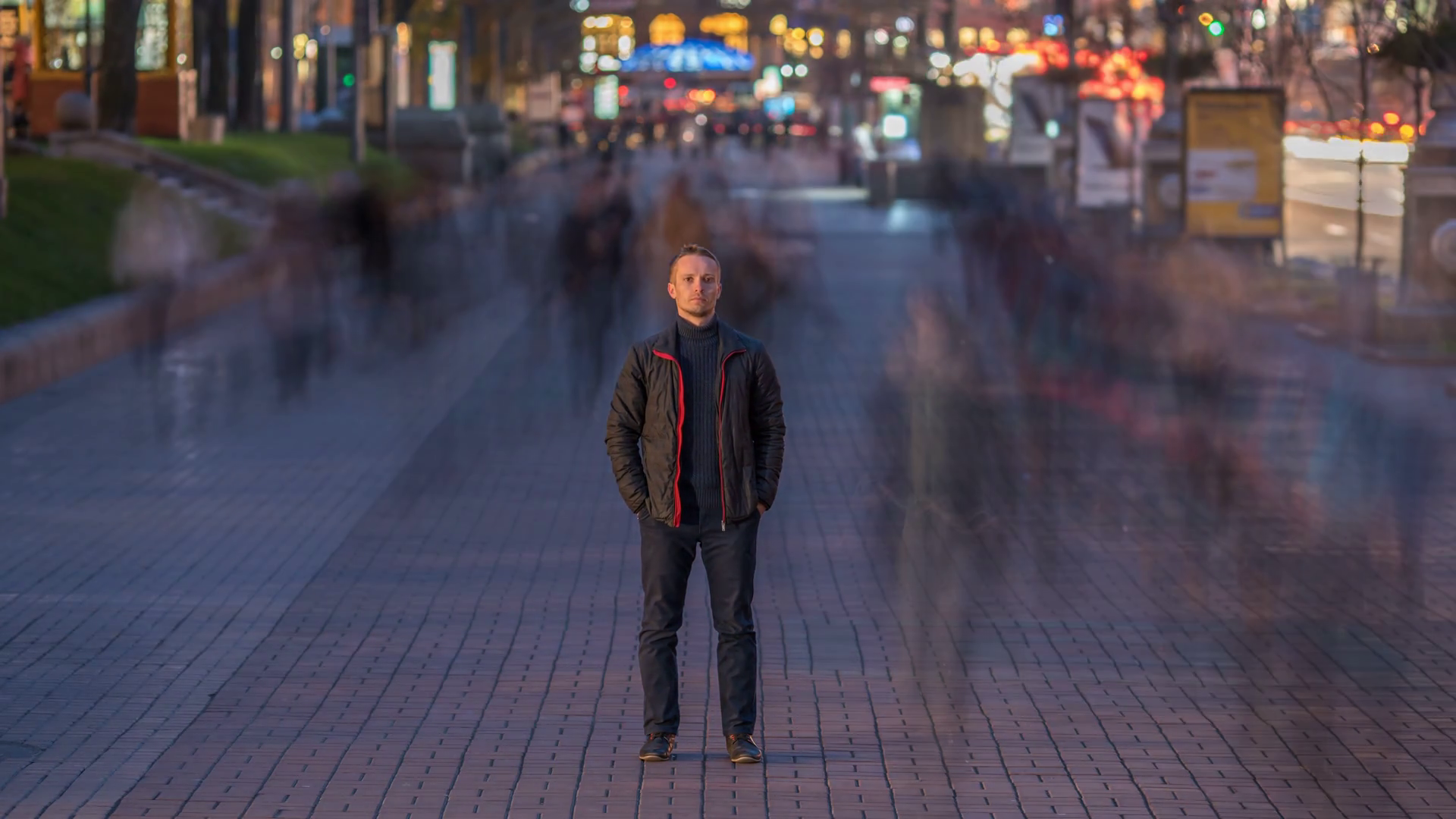 The man stand in the ghost-like crowd flow. Evening to night time. Time ...