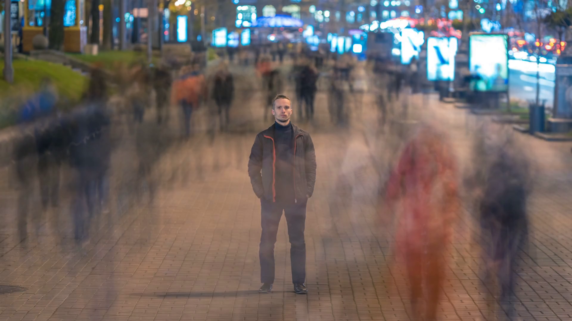 The man stand in the ghost-like crowd flow. Evening to night time. Time ...