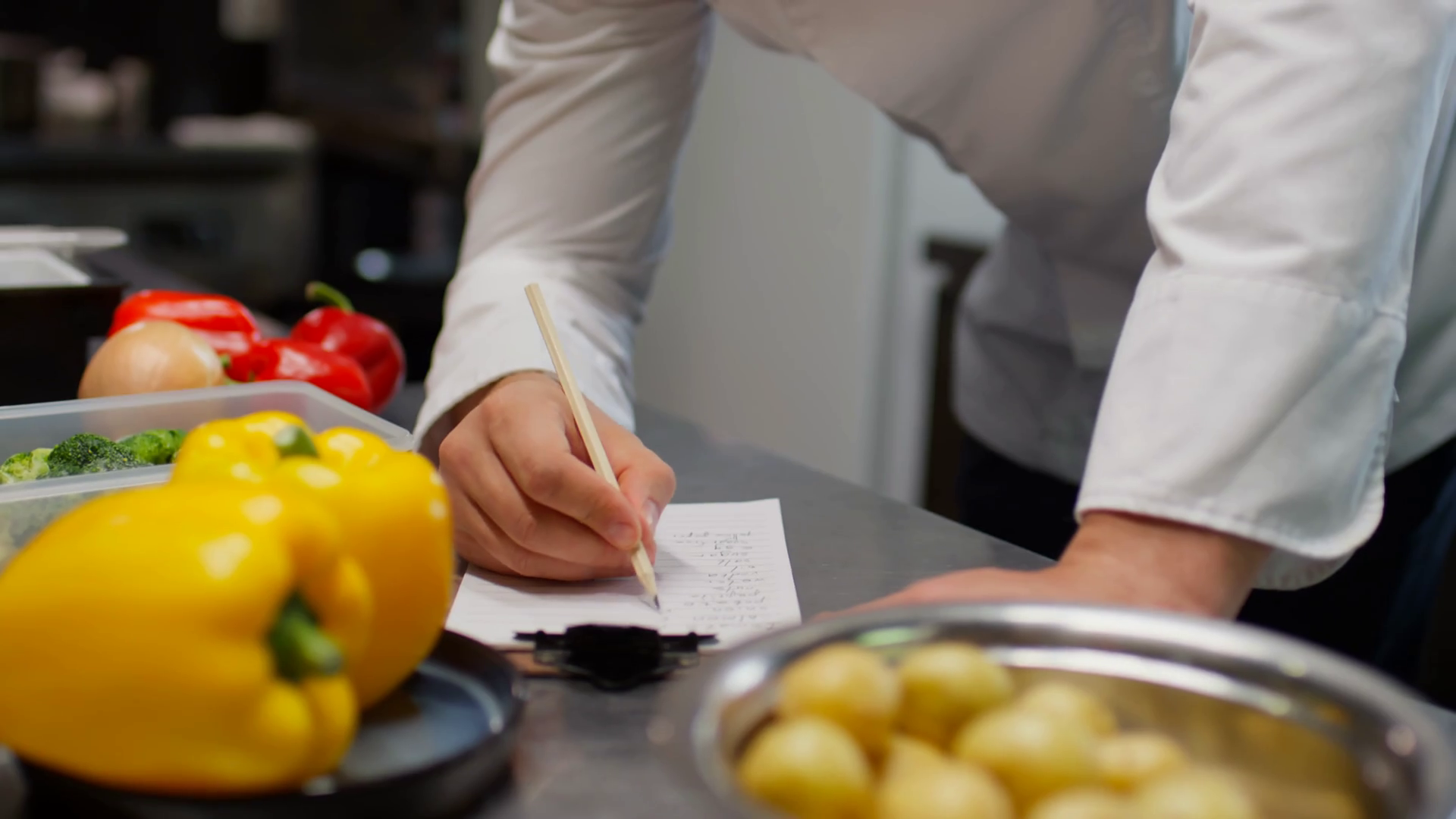Tilt Up Shot Of Chef Writing Down List Of Stock Footage SBV-346970797 ...