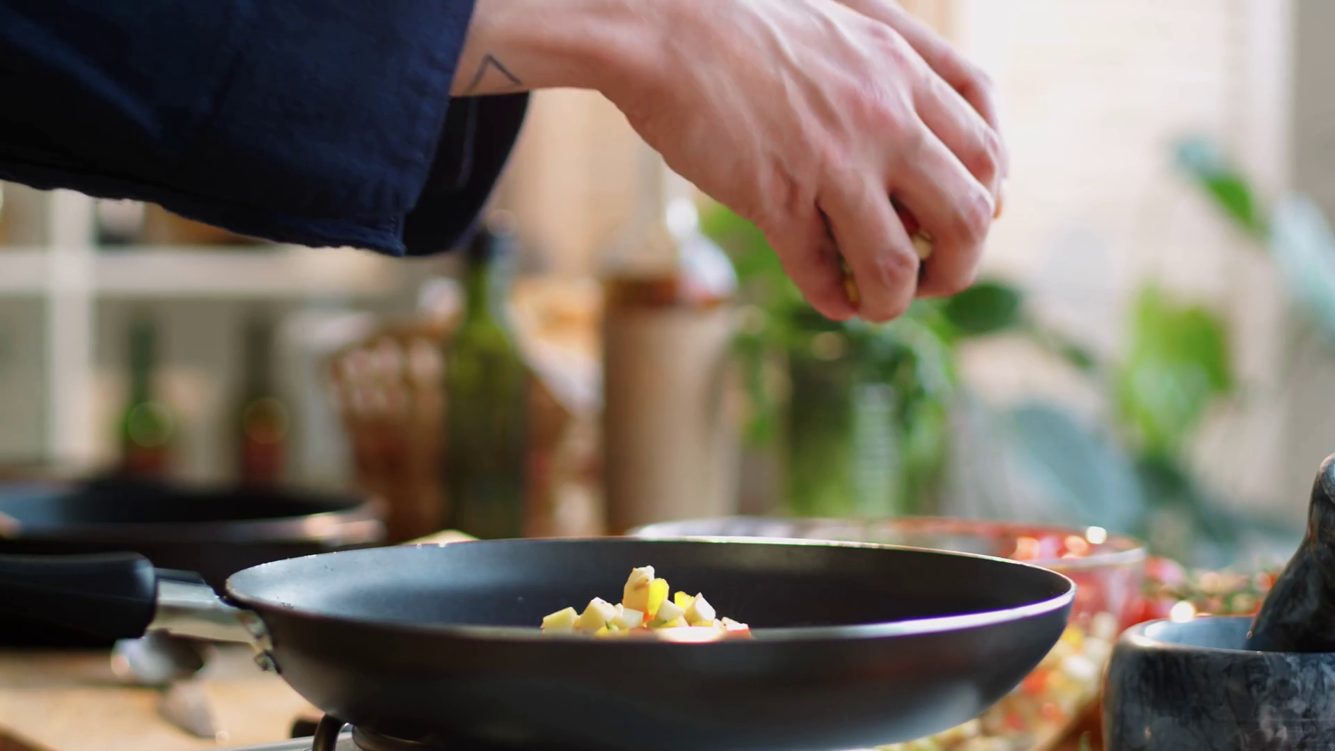 Close up shot of hands of male restaurant cook putting diced vegetables ...