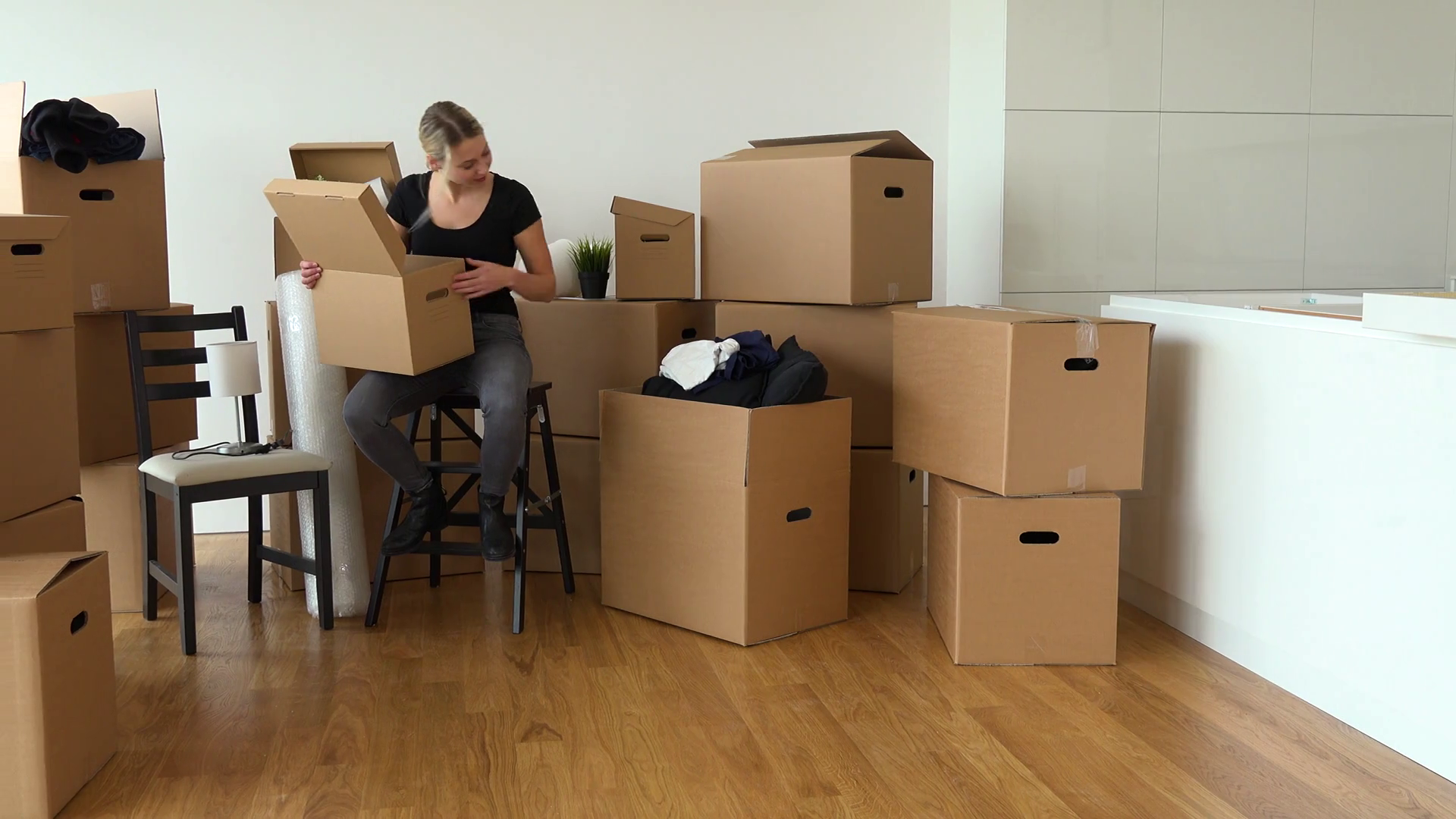 A Moving Woman Sits On Chair Puts Things Stock Footage SBV-337219234 ...