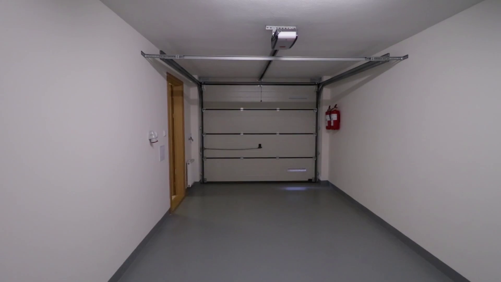 Video of an empty garage, camera goes from close up image of the door ...