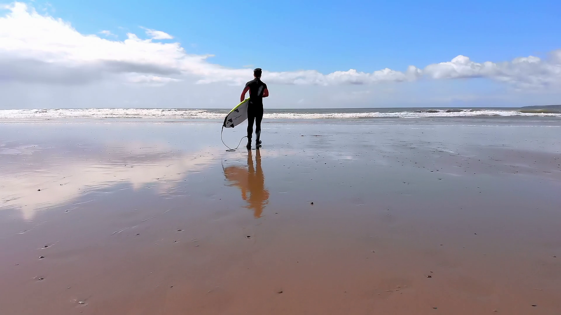 Male surfer walking with surfboard at beach on a sunny day 4k Stock ...