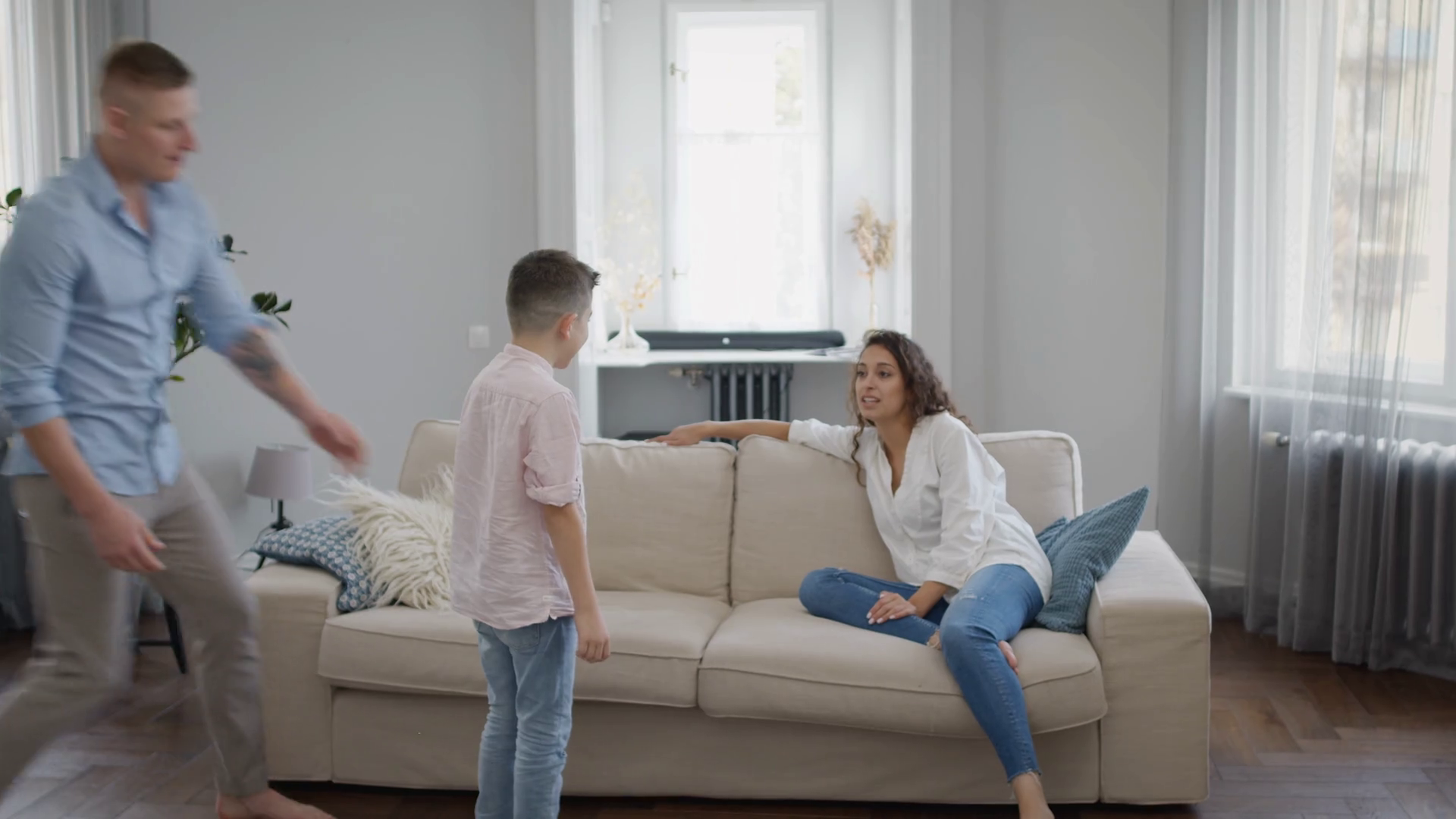 Young Family In The Apartment. They Have Fun. Beautiful Interior In ...