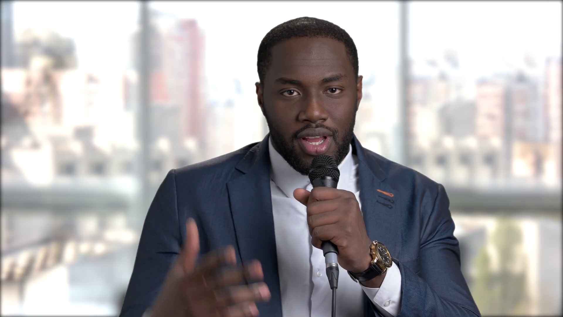 Black man in suit is singing with microphone. Handsome dark-skinned ...