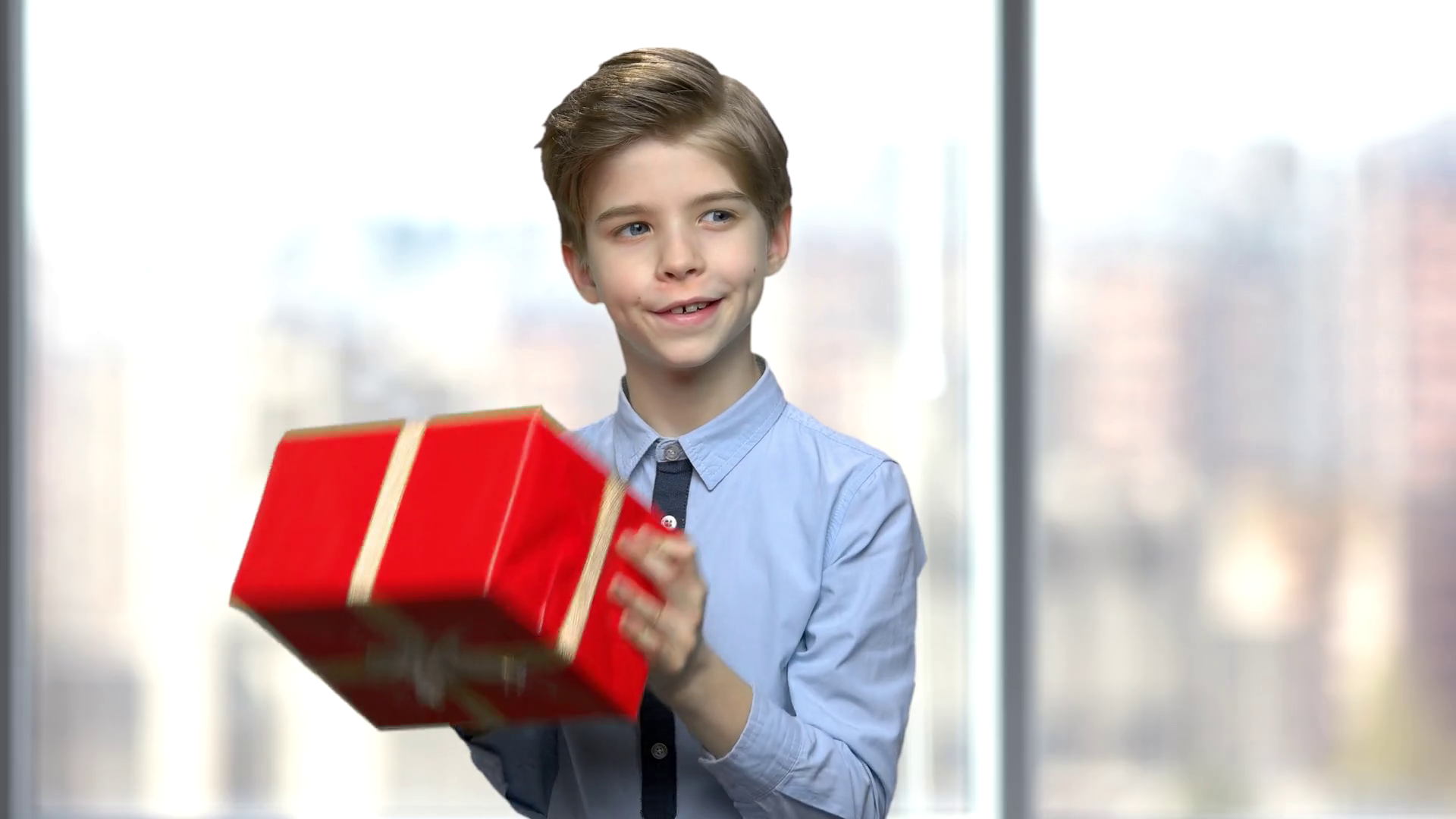 Boy shaking a box with a gift. Adorable kid giving gift box on blurred ...