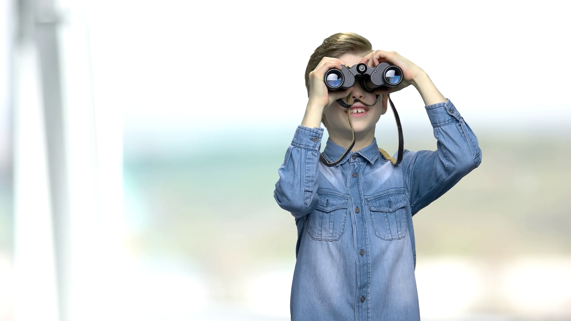 Little boy looking through binoculars. Curious child in denim jacket ...