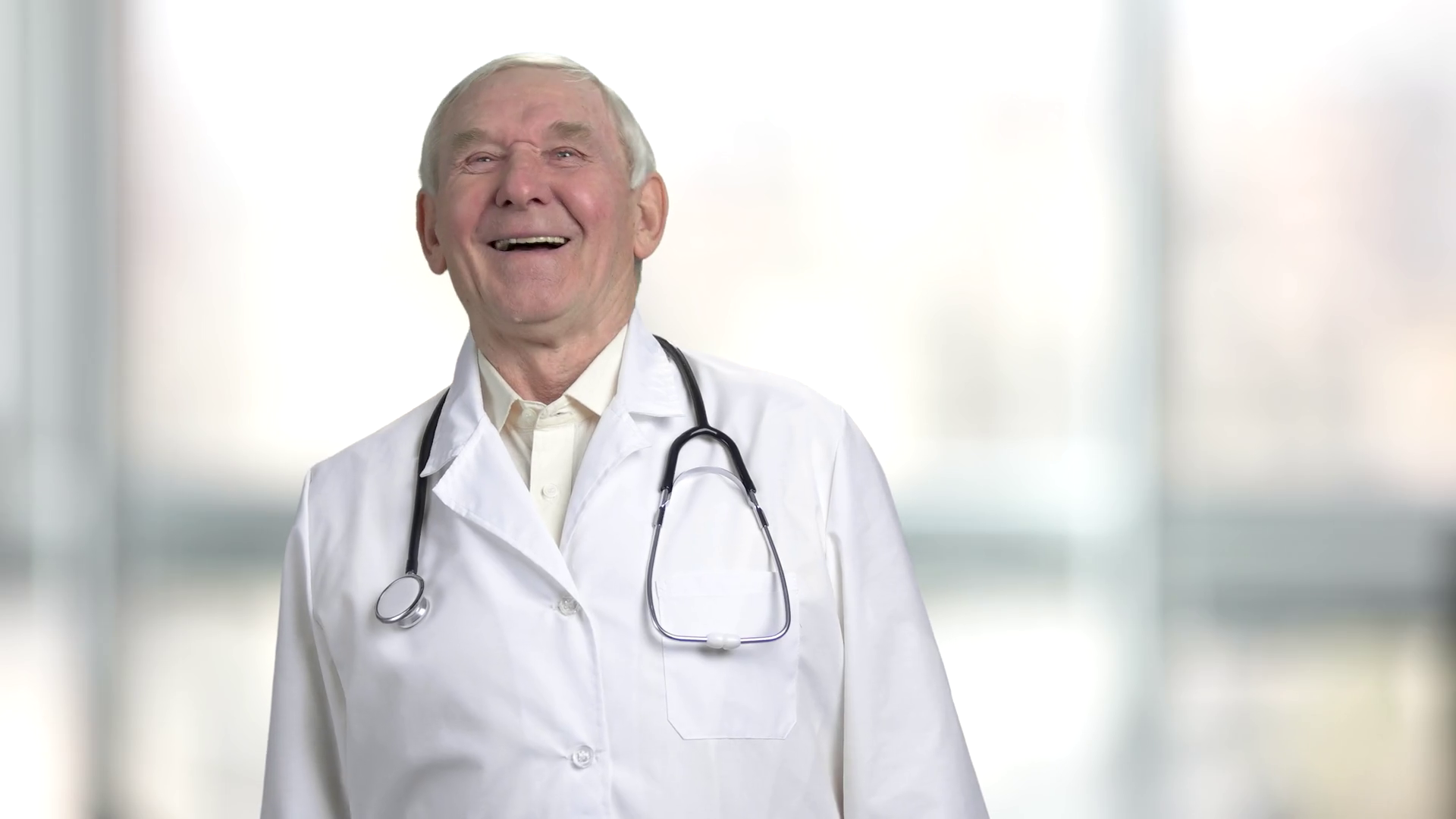 Old doctor laughing and putting hands up. Aged friendly physician ...