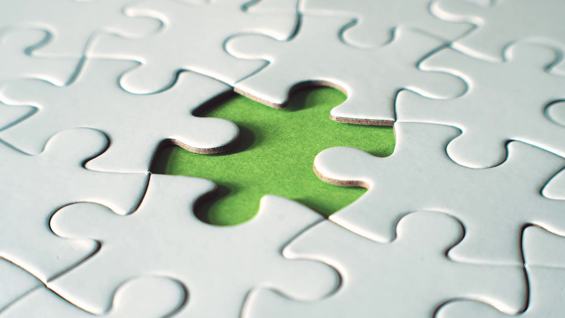 Hand putting up the last piece of a puzzle. Jigsaw Puzzle piece coming ...