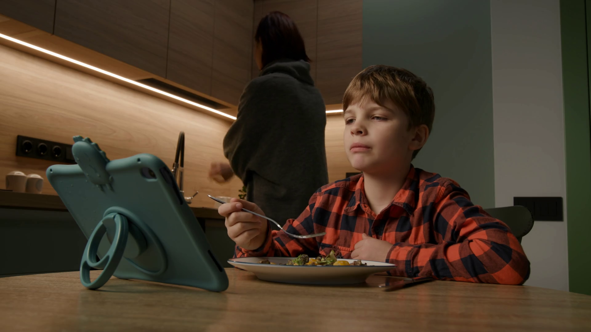 Boy Eating Watching Tablet Mom Washes Dishes Stock Footage SBV ...