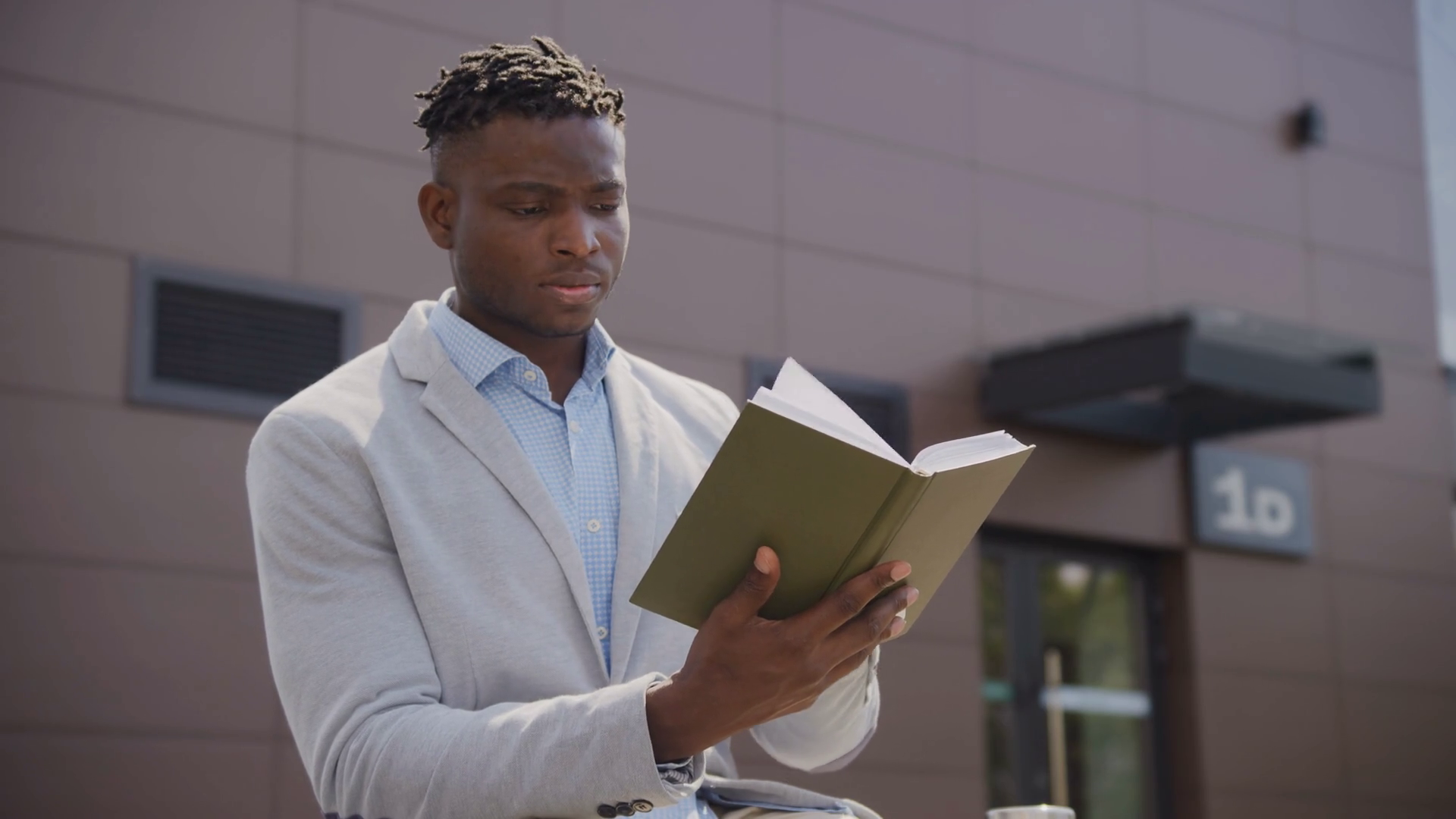 Black Man Reading Book Sitting Outdoors Stock Footage SBV-348423095 ...