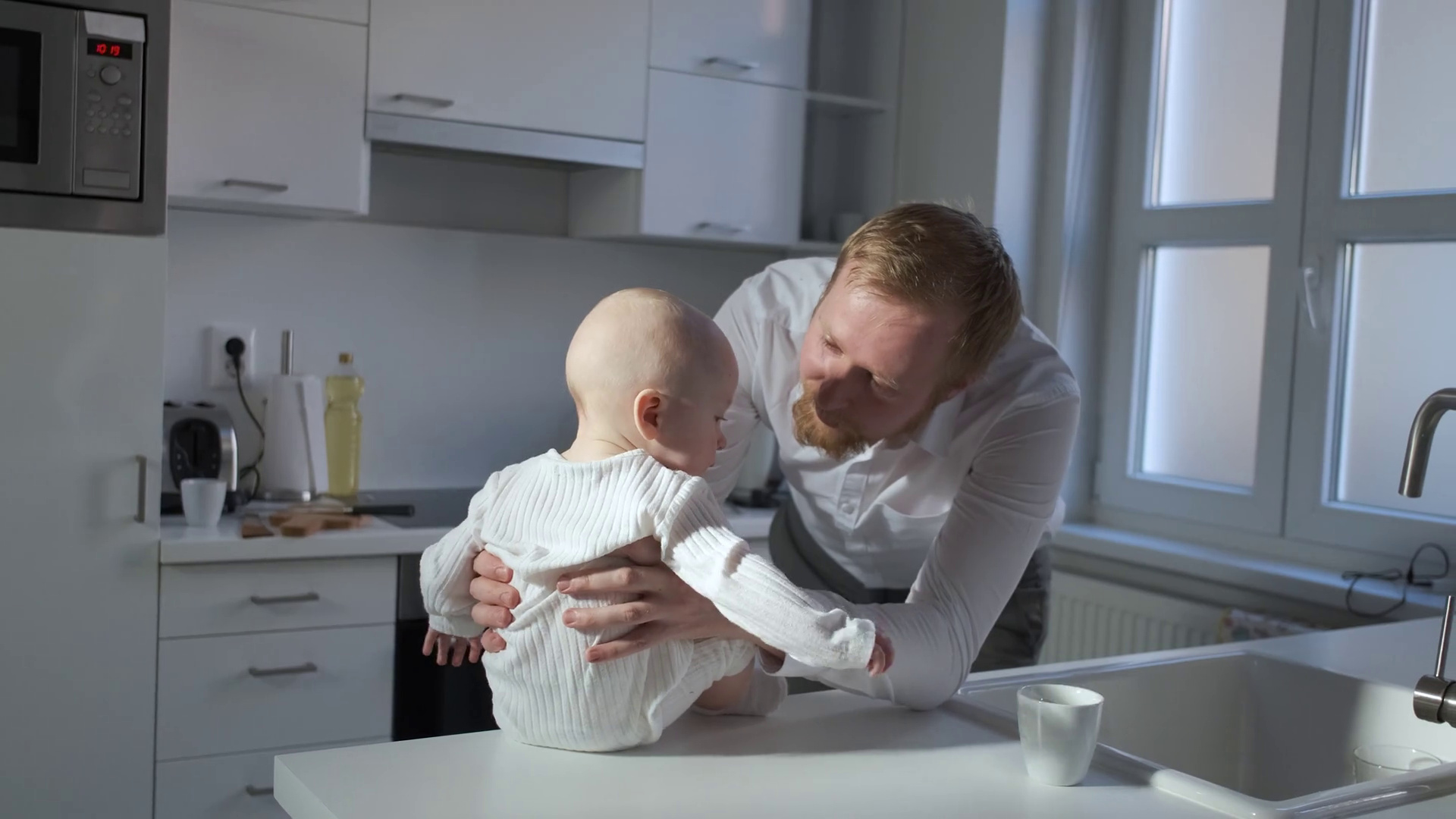 Father Talking To Toddler Son In The Kitchen In The Morning Stock Video father-talking-to-toddler-son-in-the-kitchen-in-the-morning-stock-video