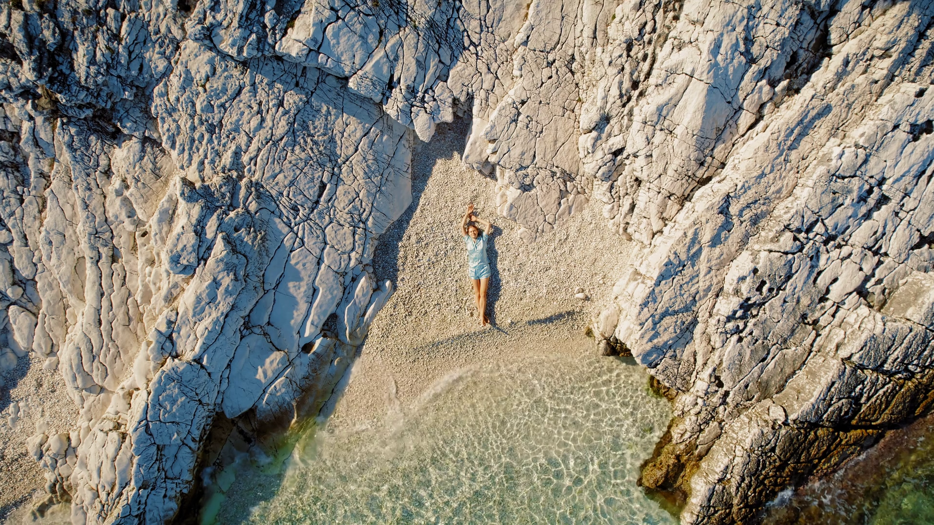 Woman Lying On Pebbled Beach Cove Between Stock Footage SBV-353142490 ...
