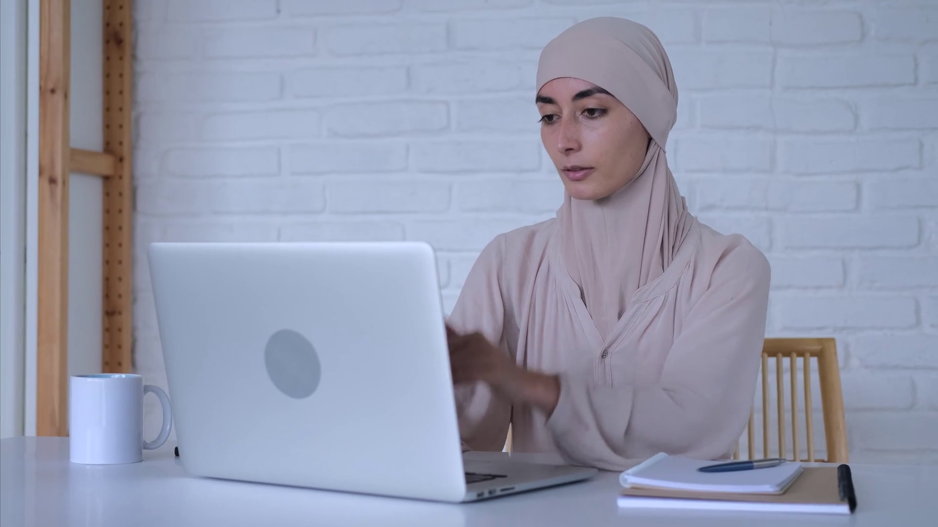 Freelancer Wearing Hijab Sits Comfortably At Stock Footage SBV ...