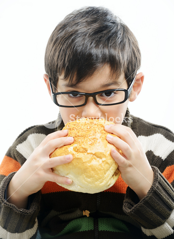 Kid eating bread bun Royalty-Free Stock Image - Storyblocks