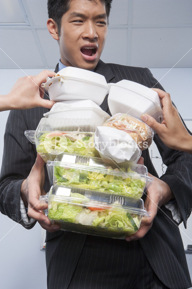Businessman hoarding food Royalty-Free Stock Image - Storyblocks
