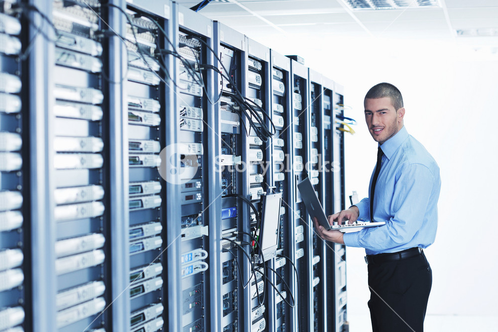 Businessman with laptop in network server room Royalty-Free Stock Image ...