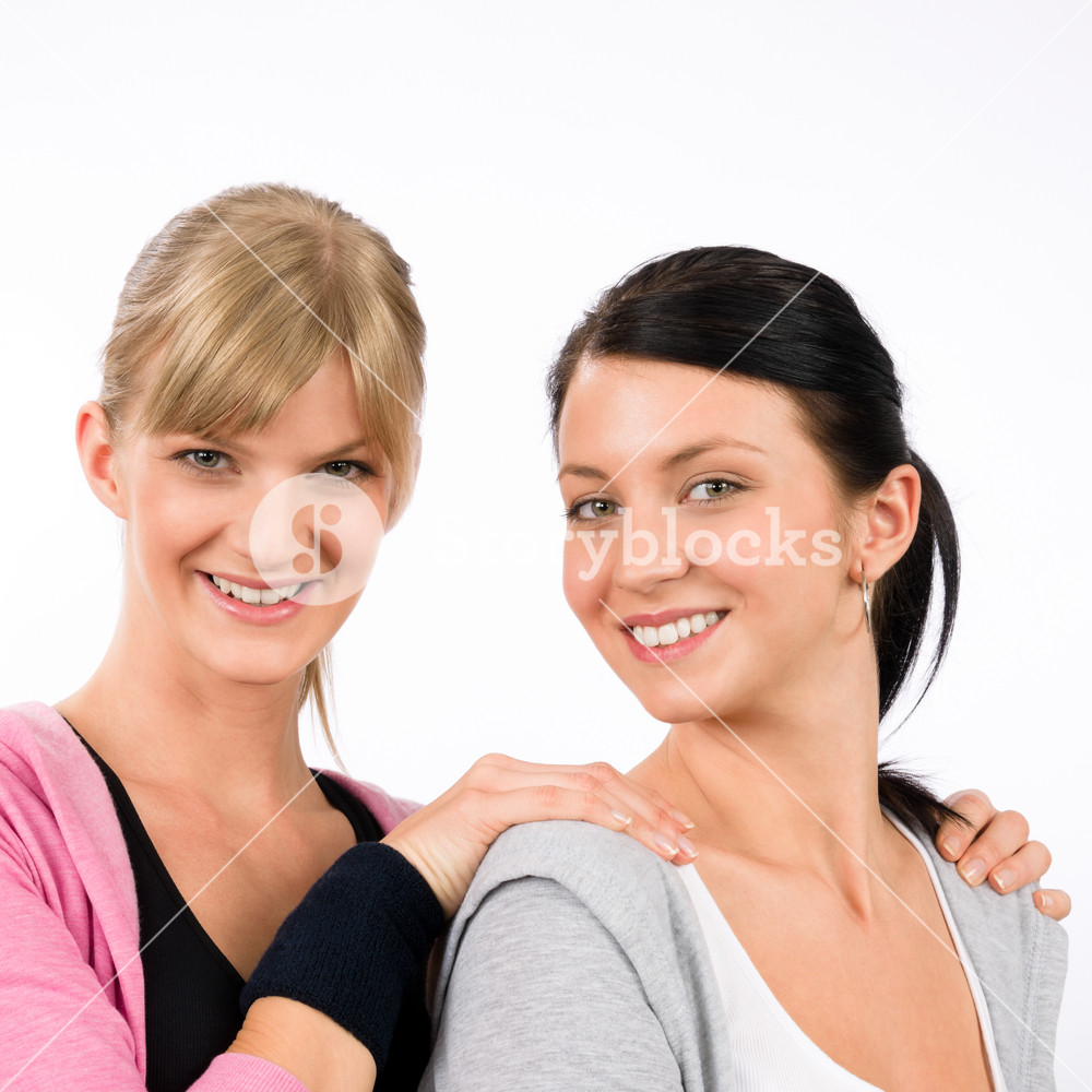 Two women friends sport outfit hugging smiling isolated portrait ...