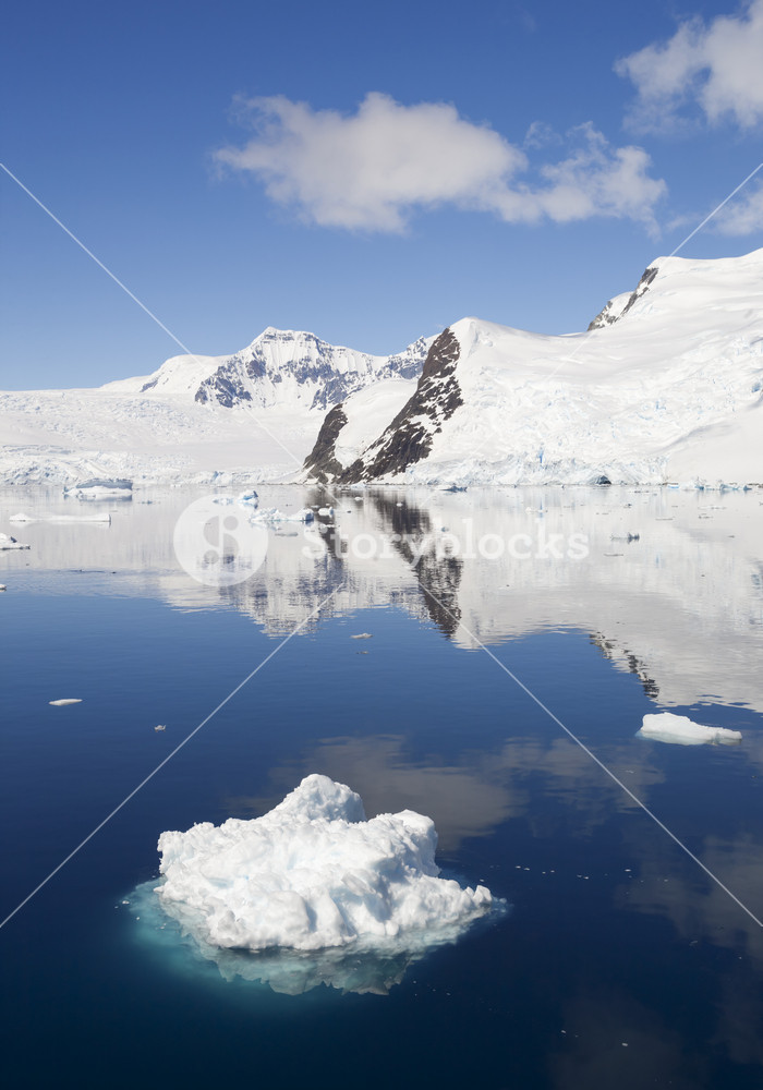 Sunlit, snowy coast and ice floe under a blue sky Royalty-Free Stock ...
