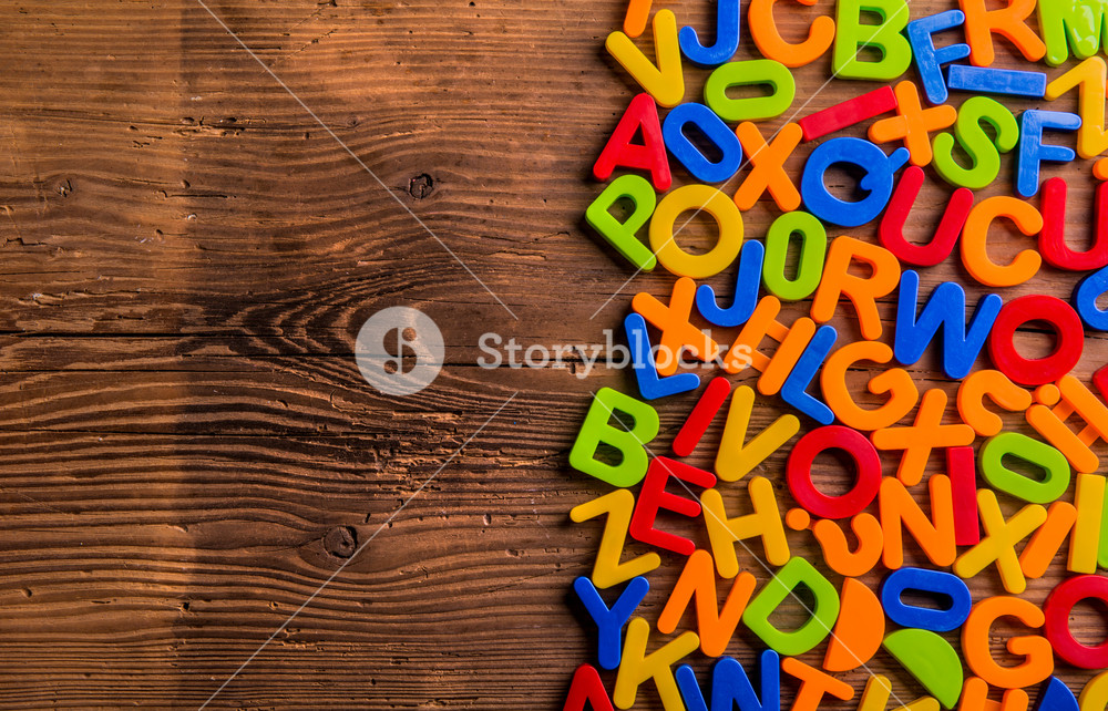 Colorful plastic letters and numbers laid on wooden background. Royalty ...