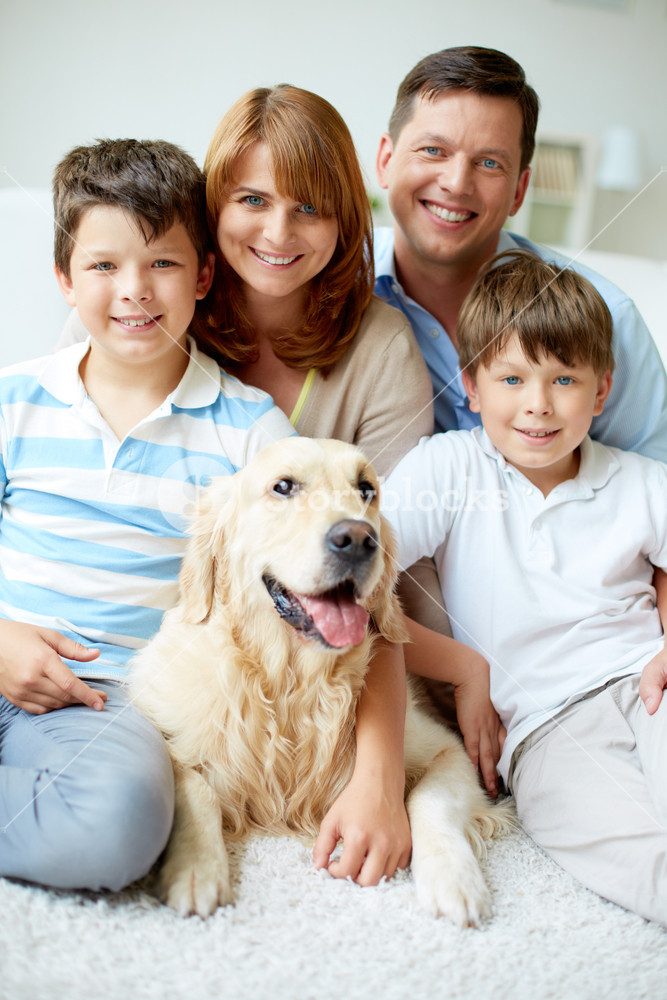 Portrait of happy family with their pet looking at camera Royalty-Free ...