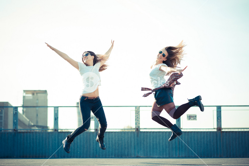 Two young women joyfully dancing in the city Royalty-Free Stock Image ...