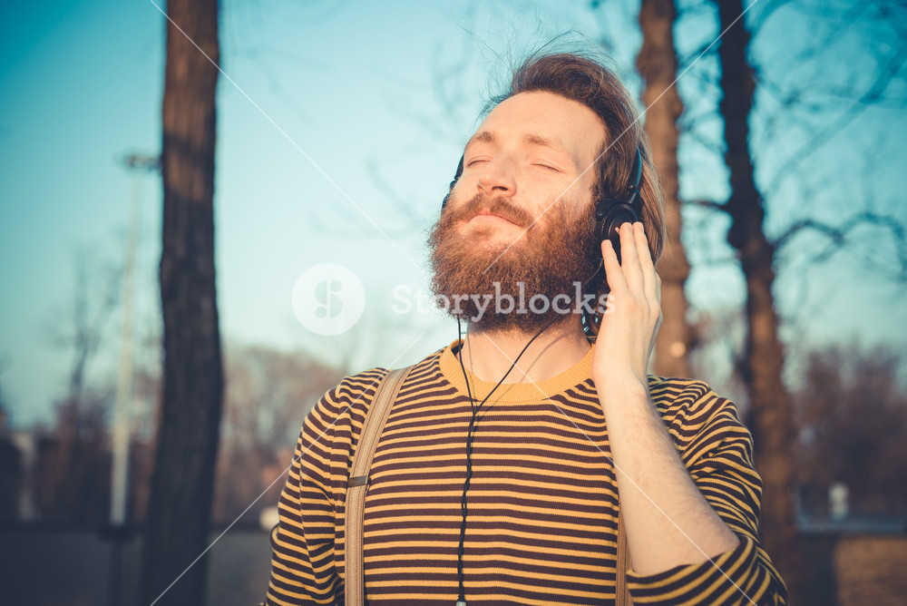 Stylish man enjoying music outdoors Royalty-Free Stock Image - Storyblocks
