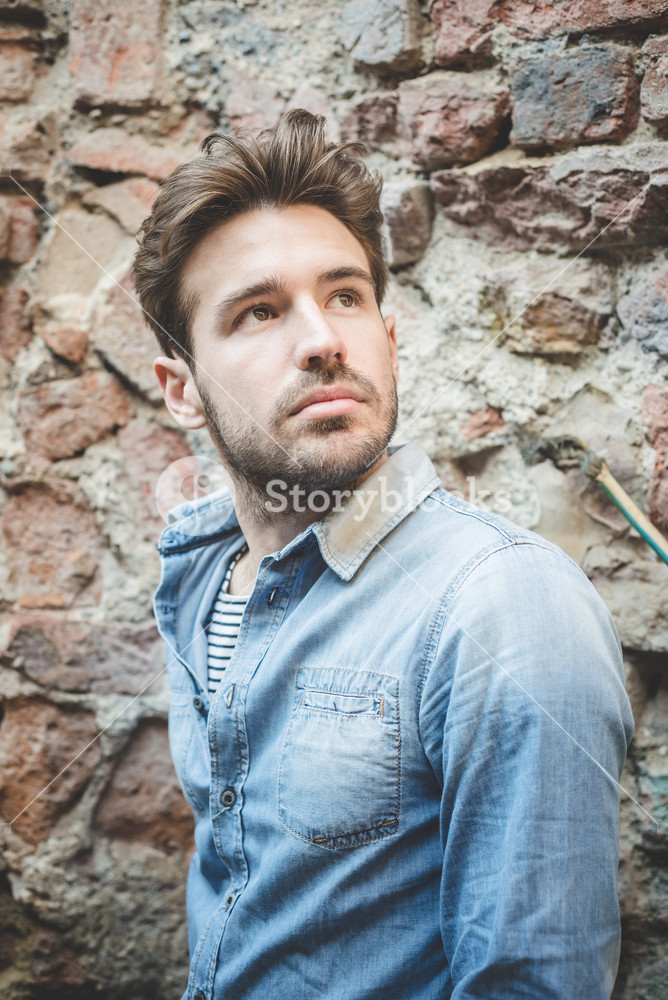 Stylish male model posing outdoors Royalty-Free Stock Image - Storyblocks