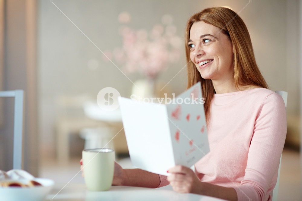 Relaxed woman with beverage reading greeting-card Royalty-Free Stock ...