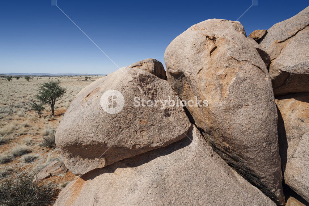 Sun-bleached rocks under a blue sky Royalty-Free Stock Image - Storyblocks